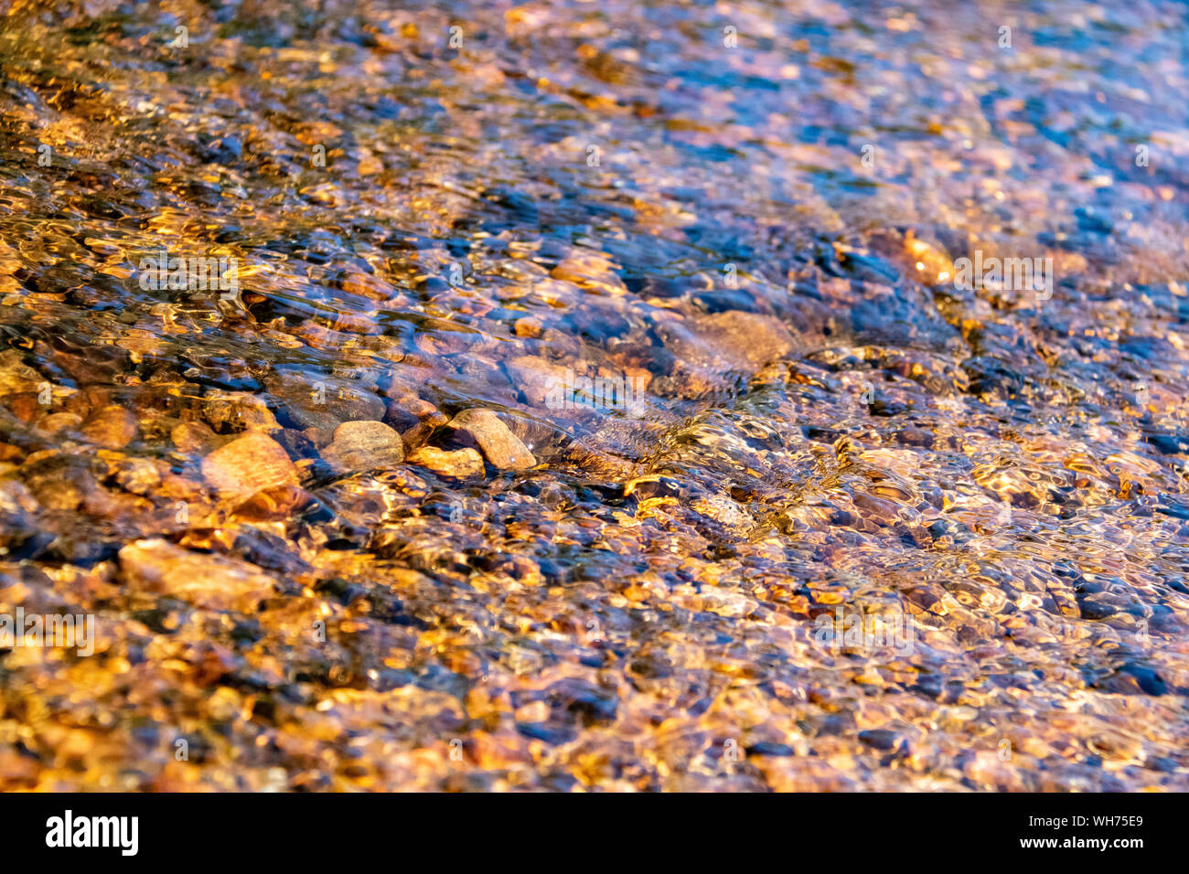 Water flowing over pebbles in creek Stock Photo - Alamy