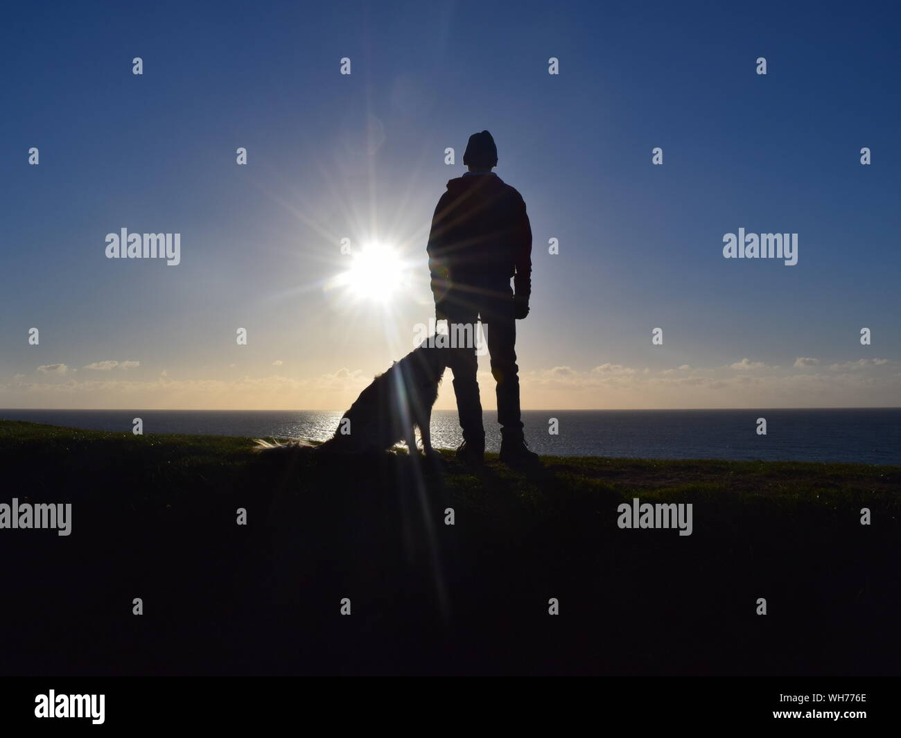 Dog Looking At Man And Sunset High Resolution Stock Photography and ...