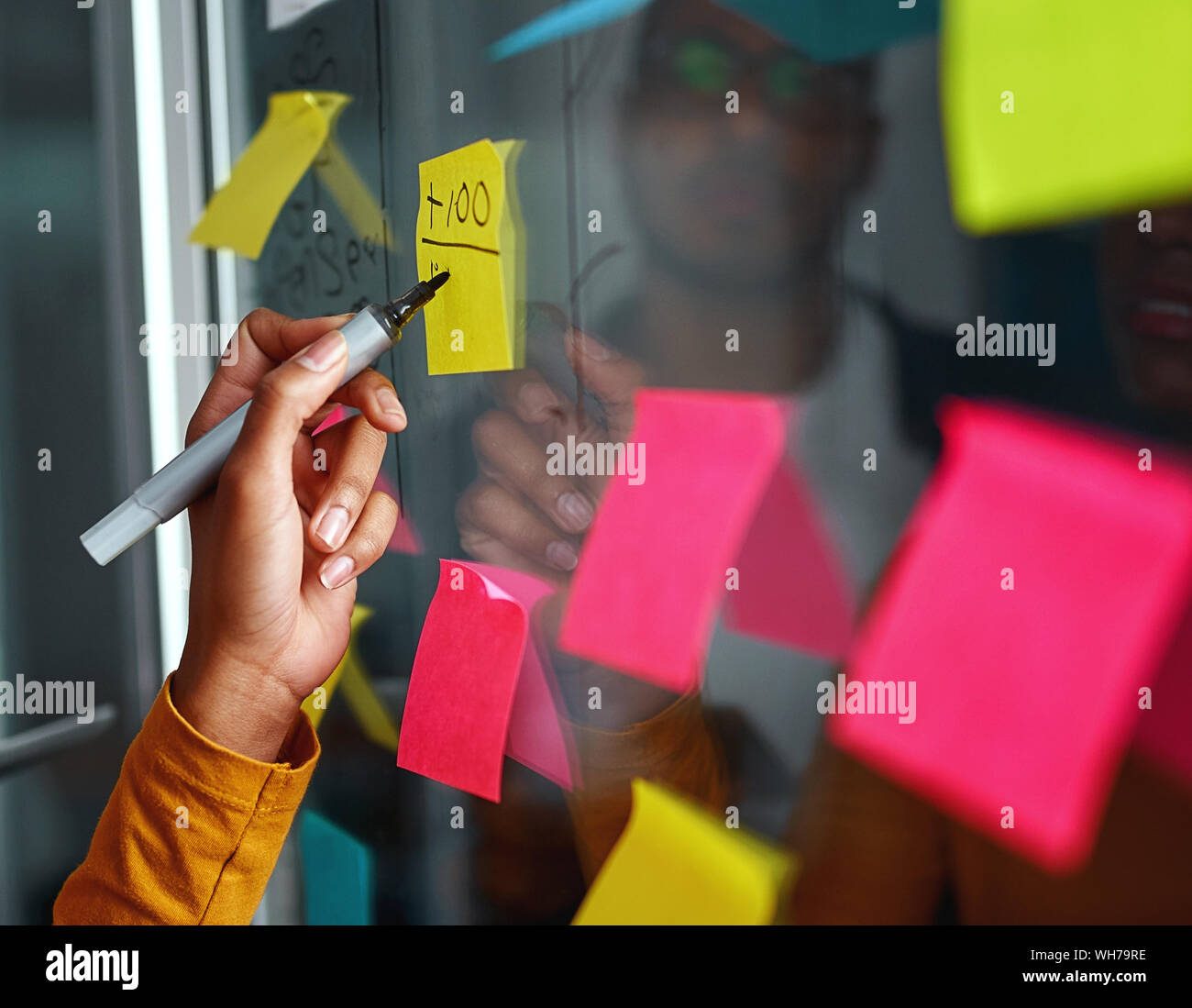 Businesswoman writing on transparent board hi-res stock photography and ...