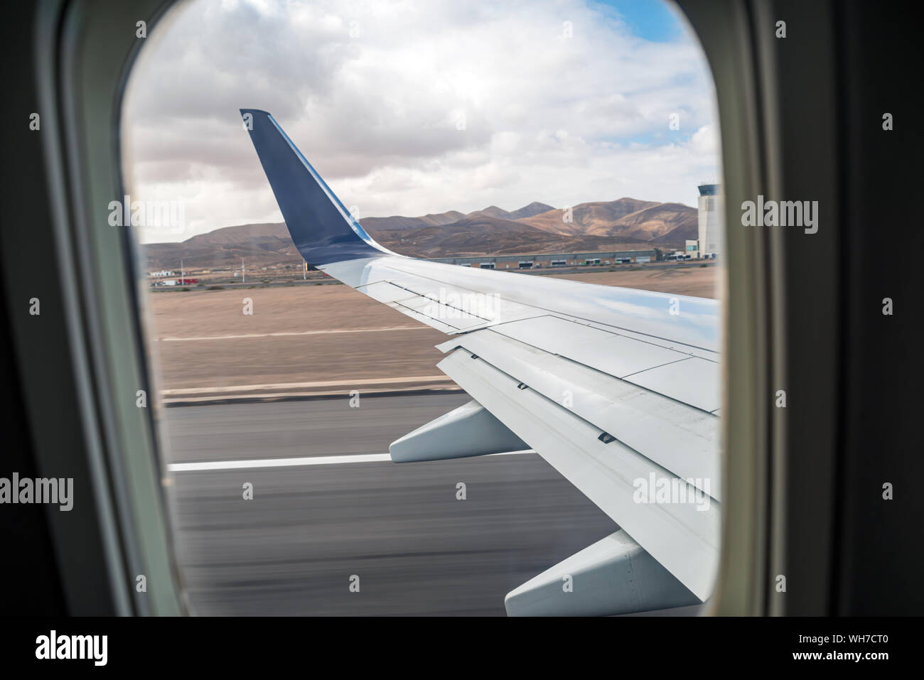 Plane takes off, looking through window of passenger frame of interior ...