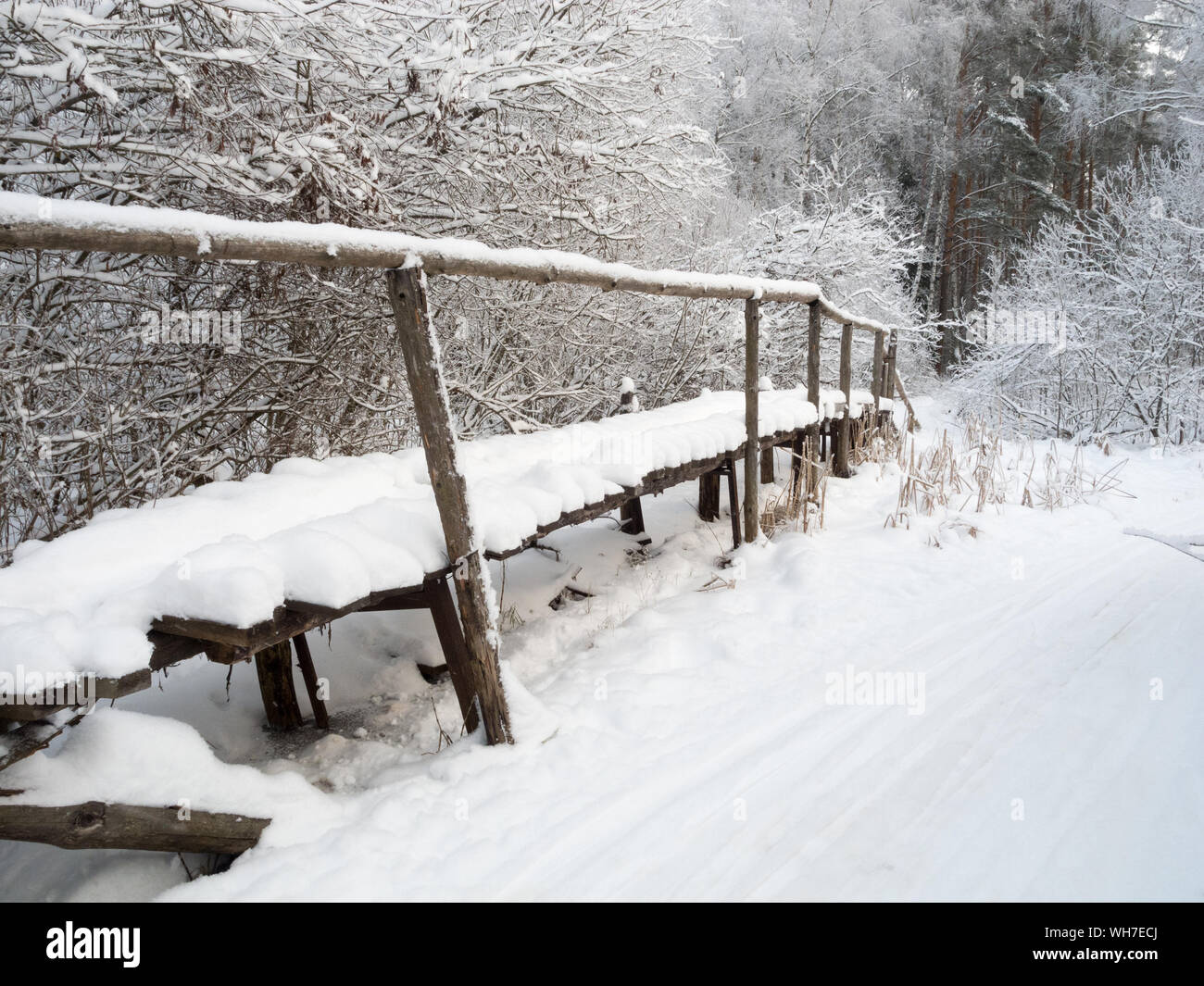 Winter landscape. Wooden bridge in the snow Stock Photo - Alamy