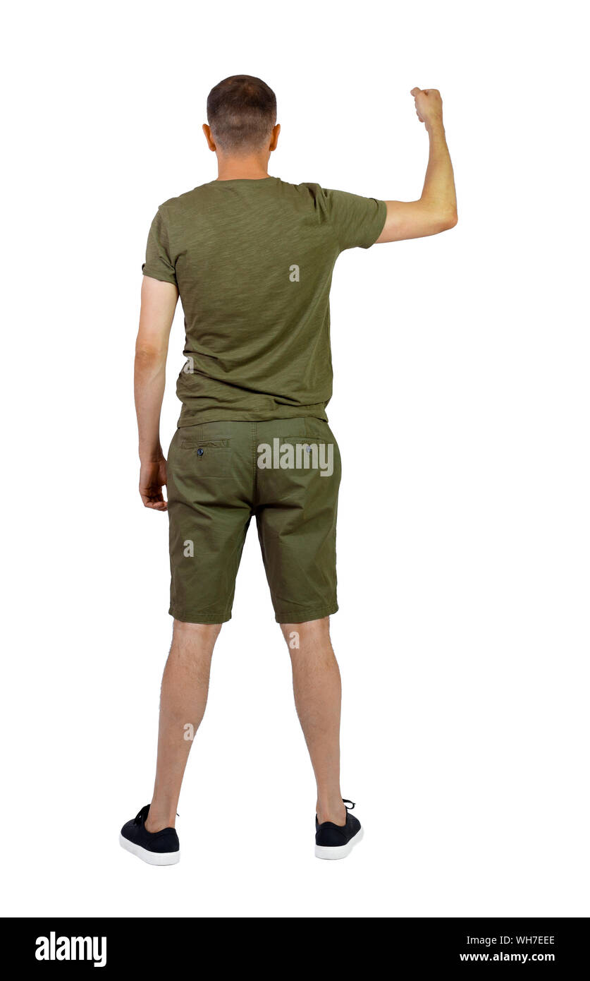 Back view of going handsome man in shorts pointing. walking young guy ...
