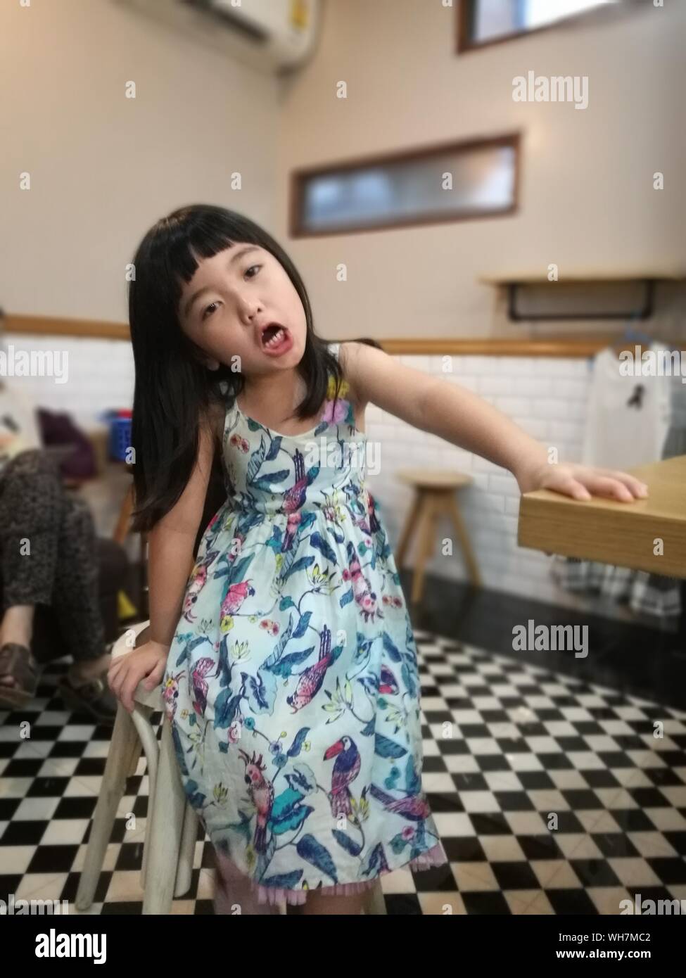 Person sitting on a stool hi-res stock photography and images - Alamy