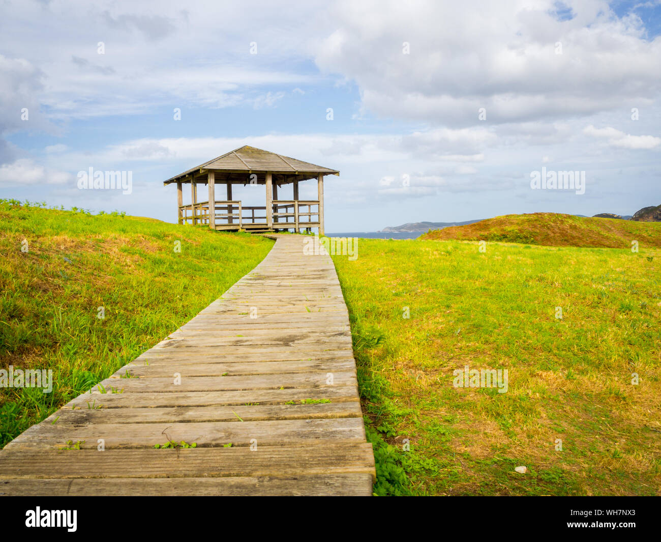 Wooden boardwalk steps leading to a lookout down to the Cantabrian sea ...