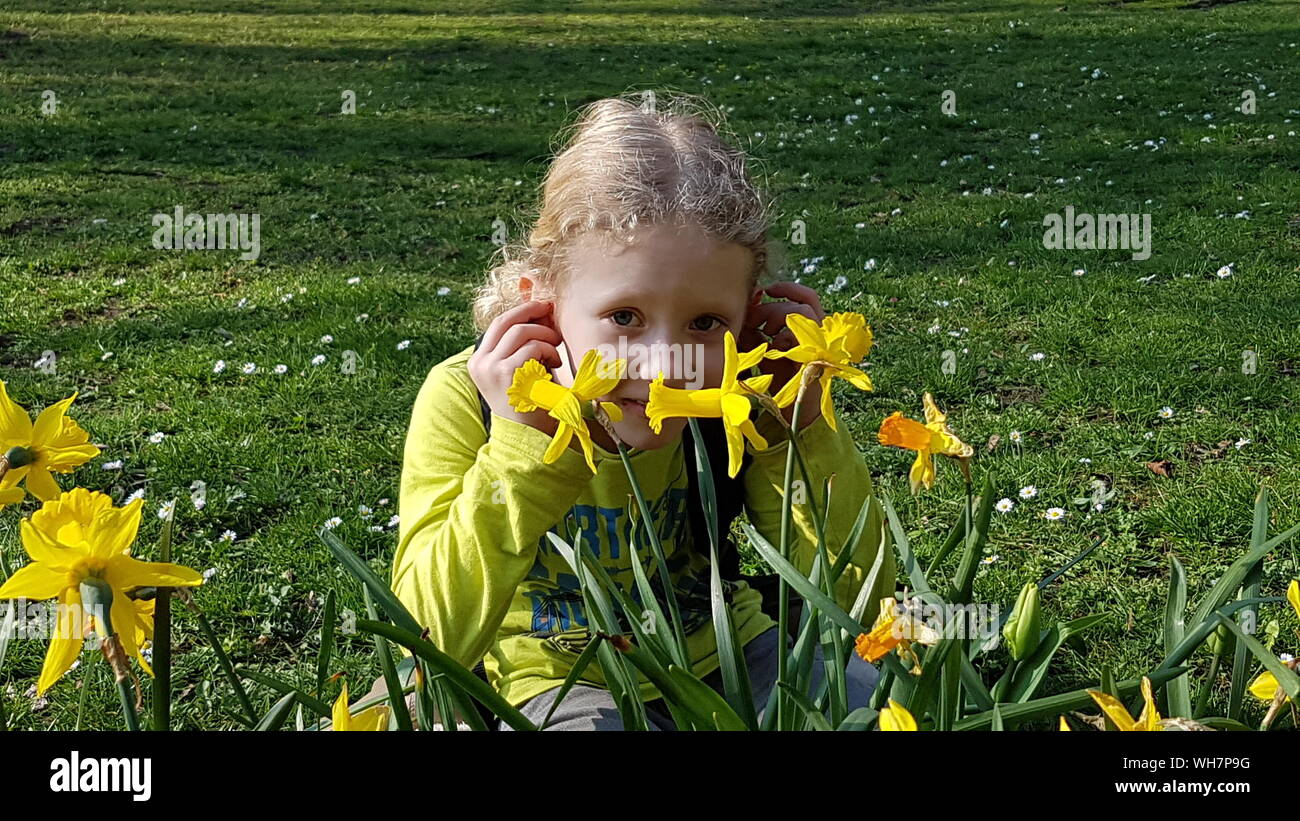 Portrait girl sitting in field hi-res stock photography and images - Alamy