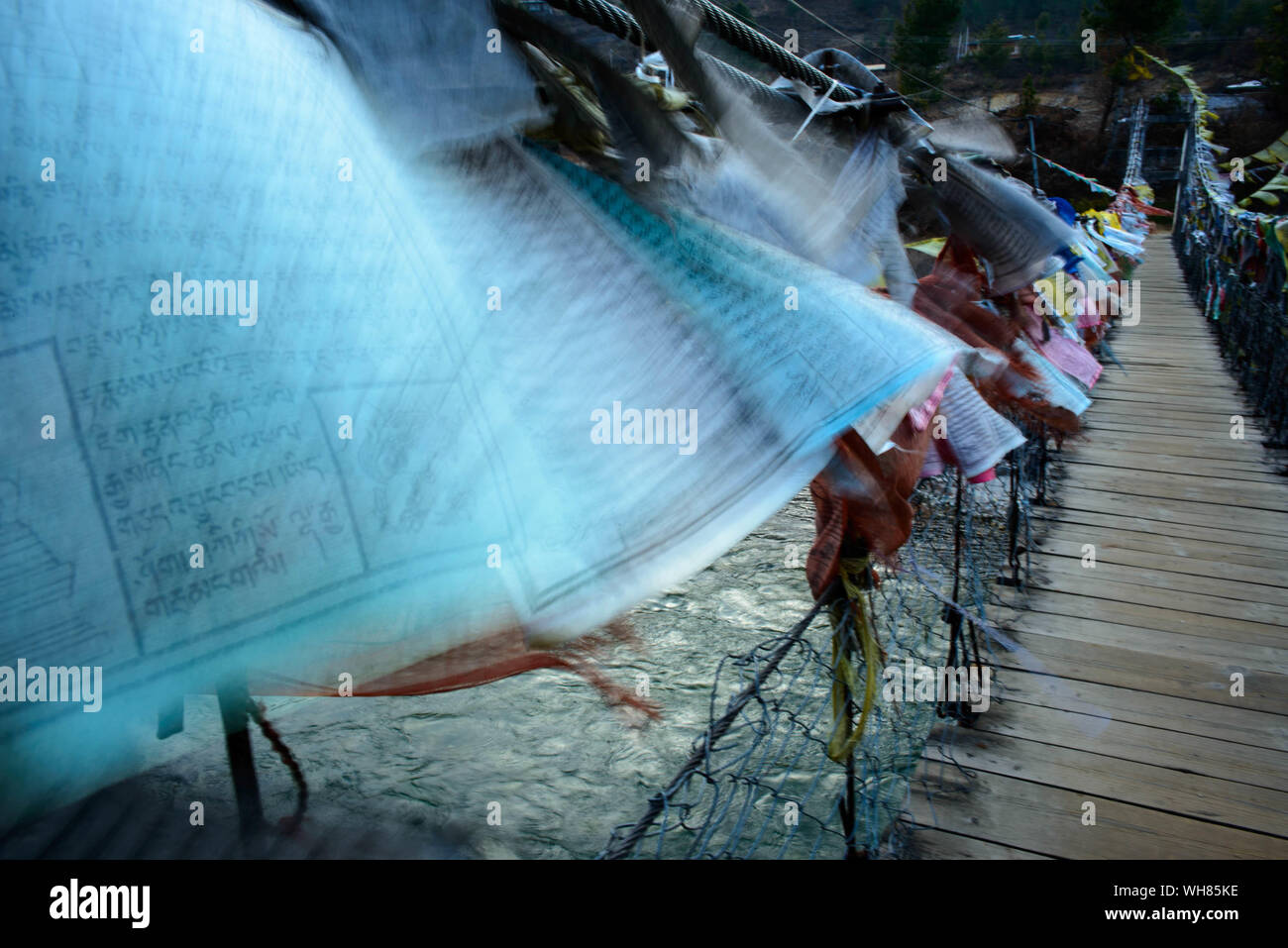 Prayer Flags On Railing Of Bridge Over River Stock Photo - Alamy