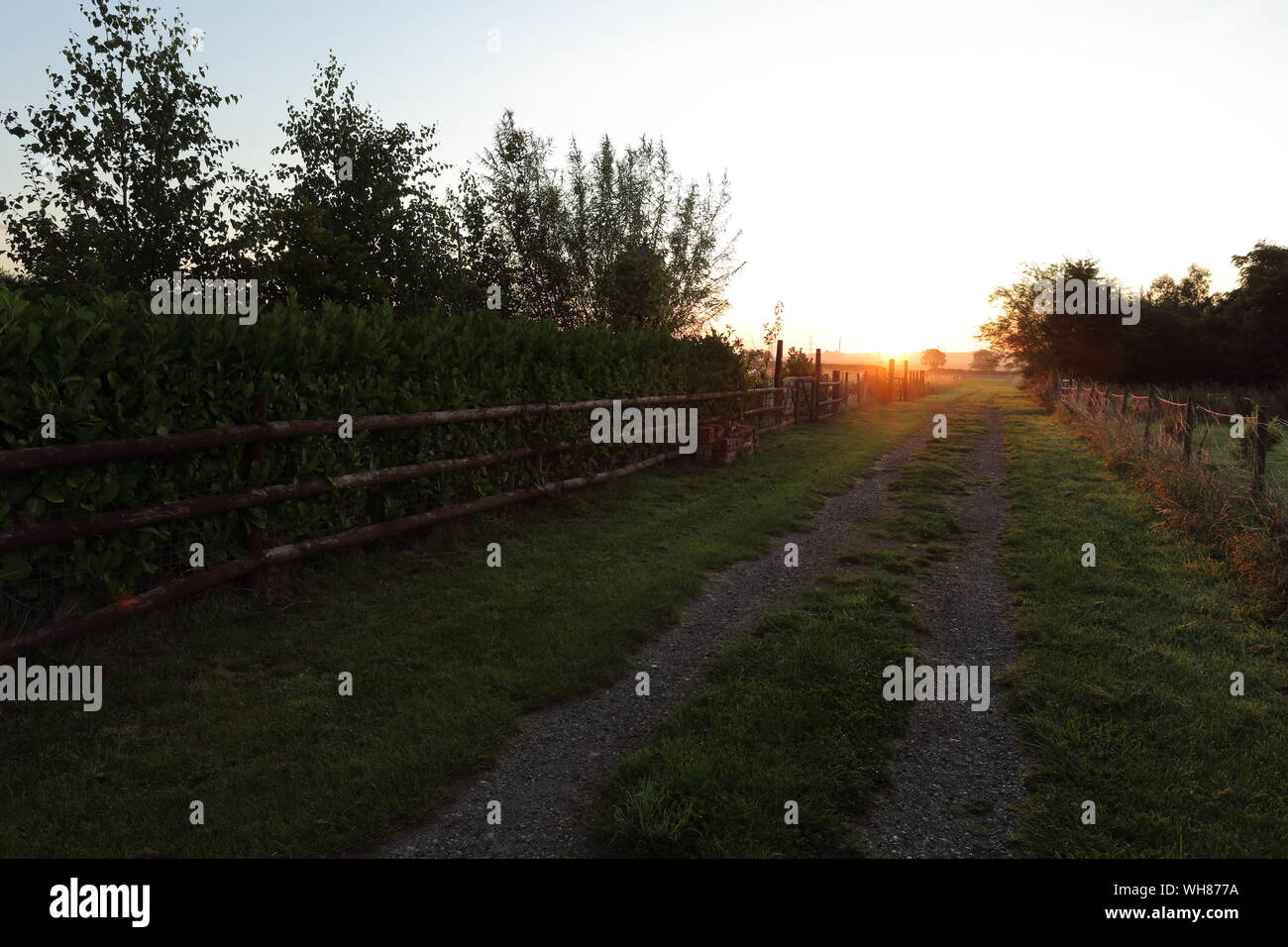 Rural path leading to the rising sun Stock Photo - Alamy