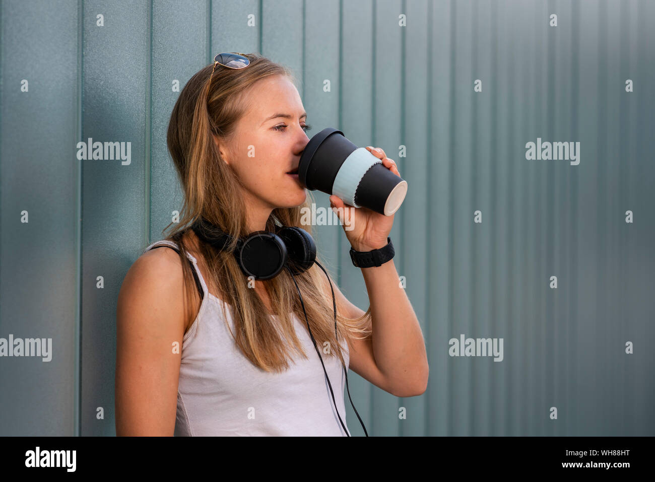 Young woman drinking coffee to go Stock Photo - Alamy
