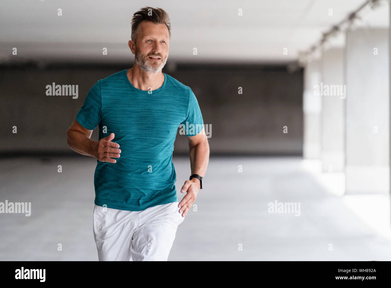 Sporty man jogging Stock Photo - Alamy
