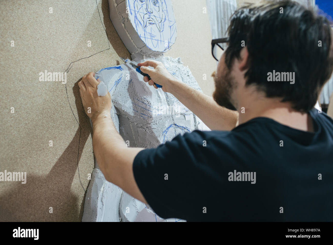 Sculptor working on a sculpture Stock Photo - Alamy