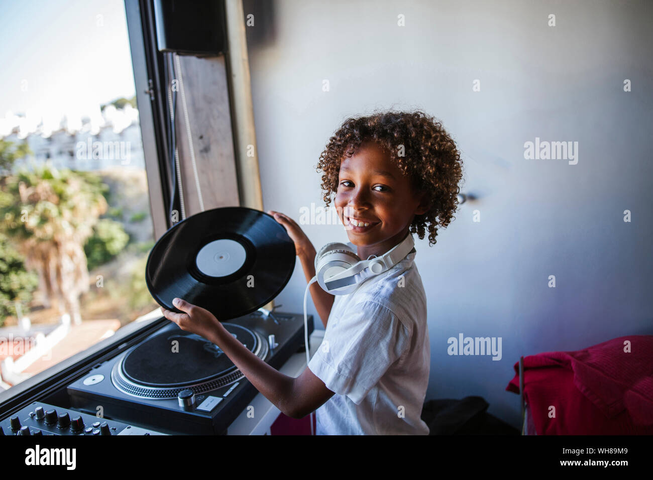 Portrait of happy young dj with vinyl record Stock Photo - Alamy