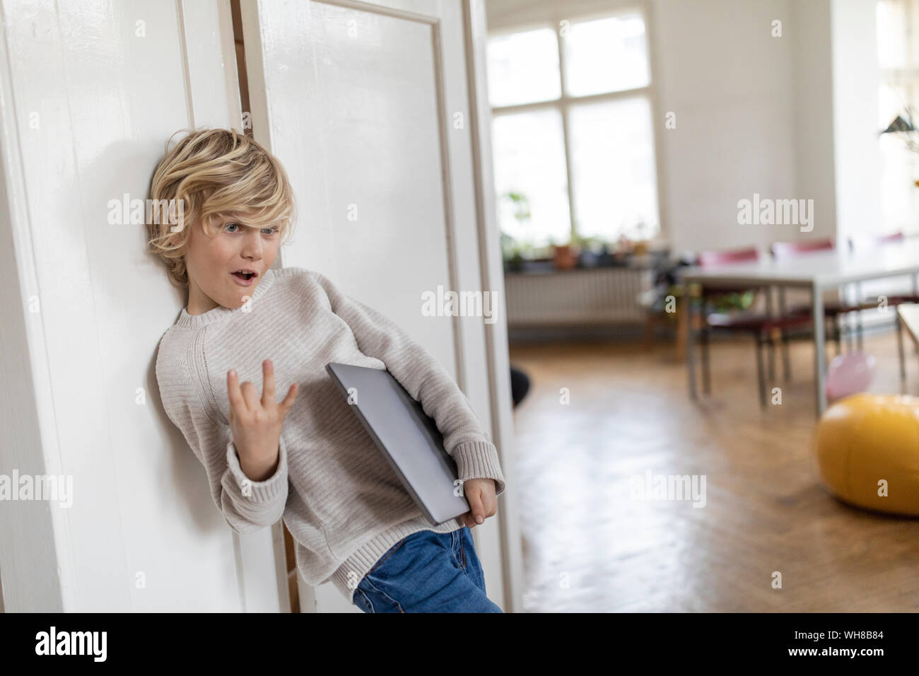 Boy posing with laptop at home Stock Photo - Alamy