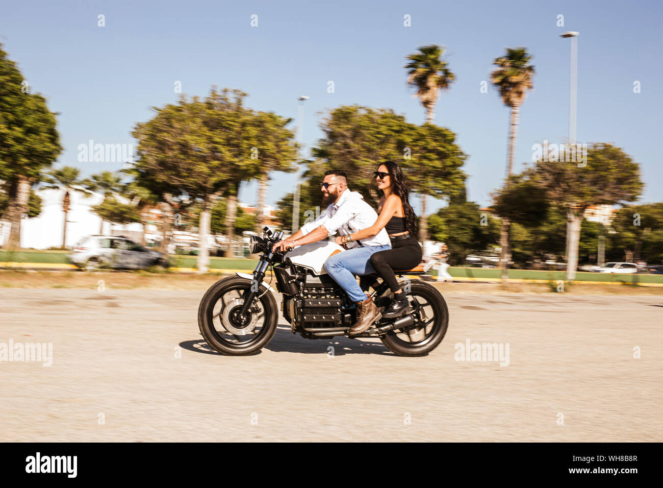 Couple riding on motorbike in summer Stock Photo - Alamy
