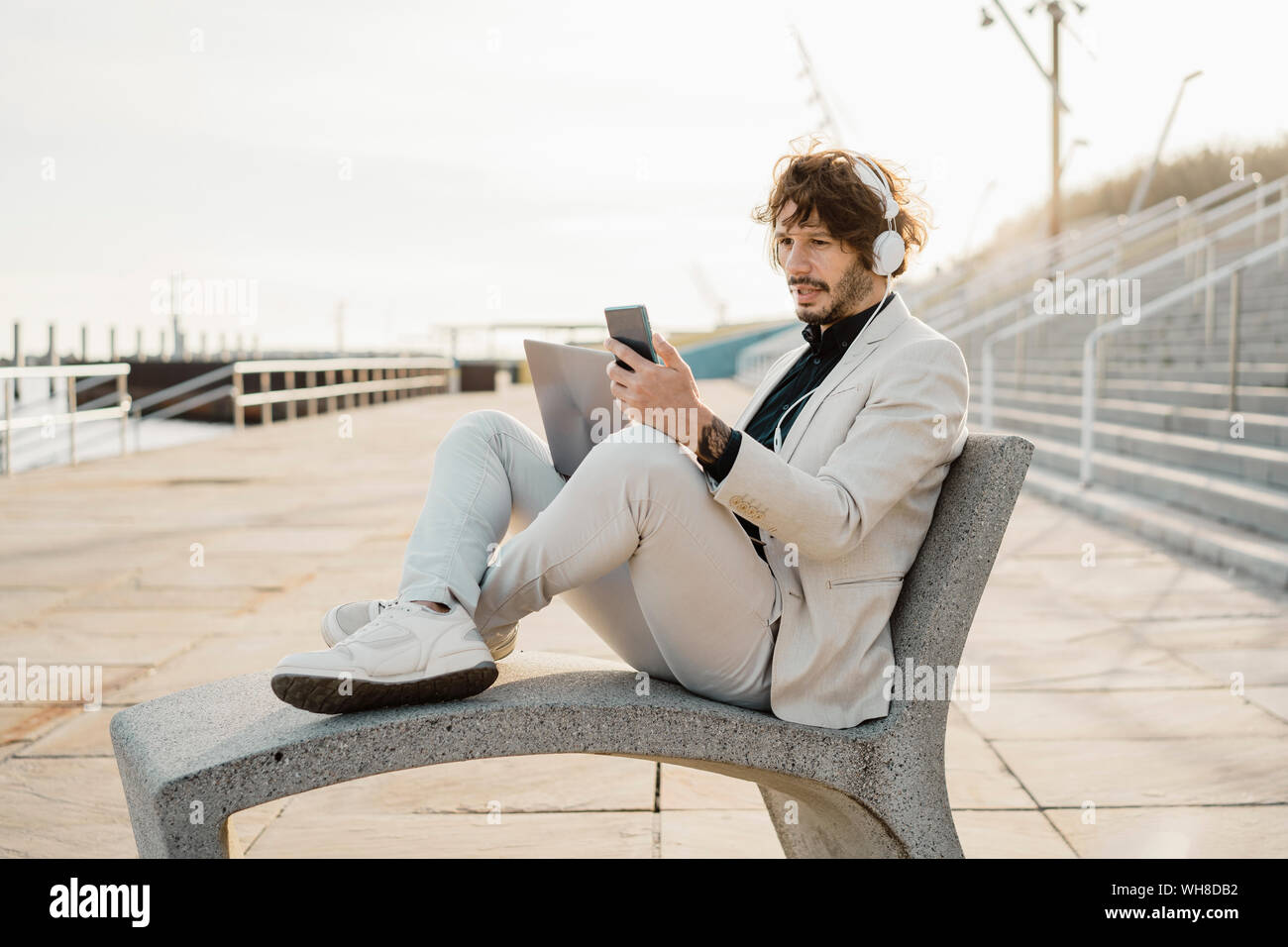 Portrait Of Shocked Businessman With Headphones And Laptop Looking At