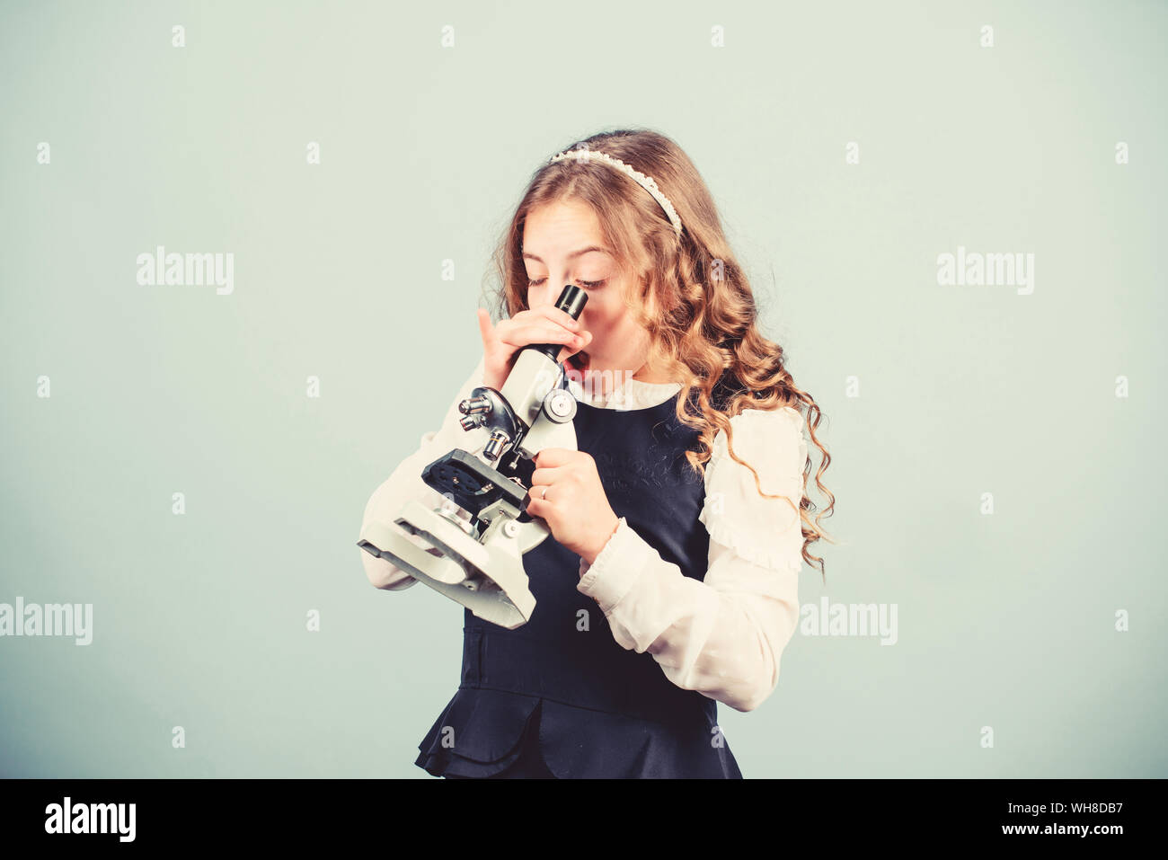science research in lab. Small genius girl with microscope. education ...