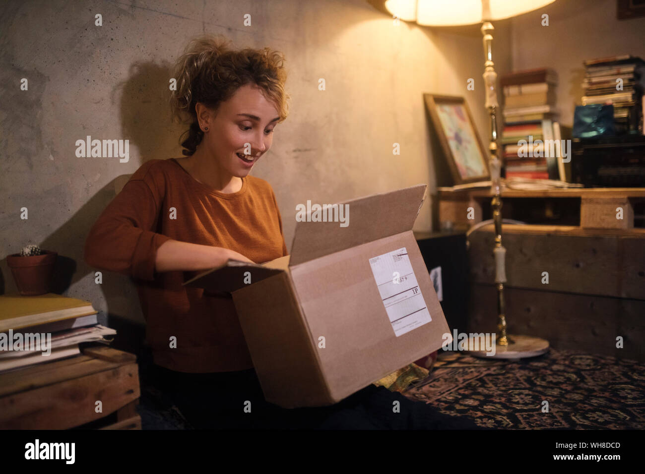 Woman unpacking parcel box hi-res stock photography and images - Alamy