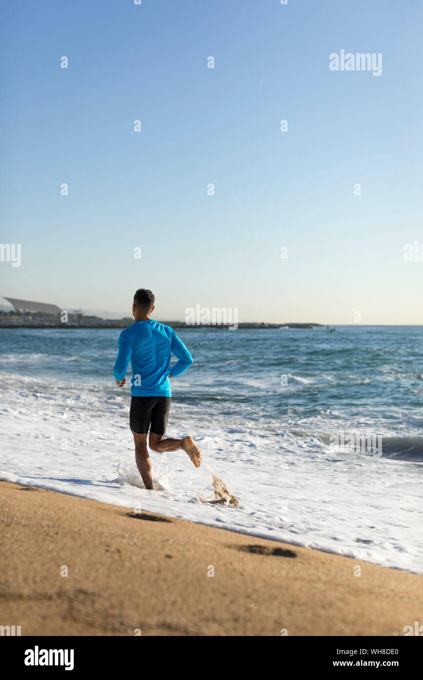 Man jogging on the beach Stock Photo - Alamy