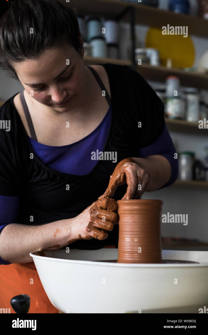 Potter forming clay on a wheel Stock Photo - Alamy