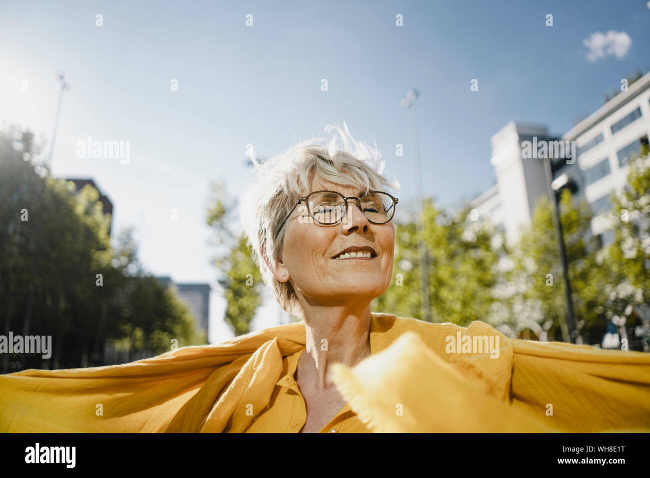 Portrait of smiling mature woman enjoying sunlight Stock Photo - Alamy