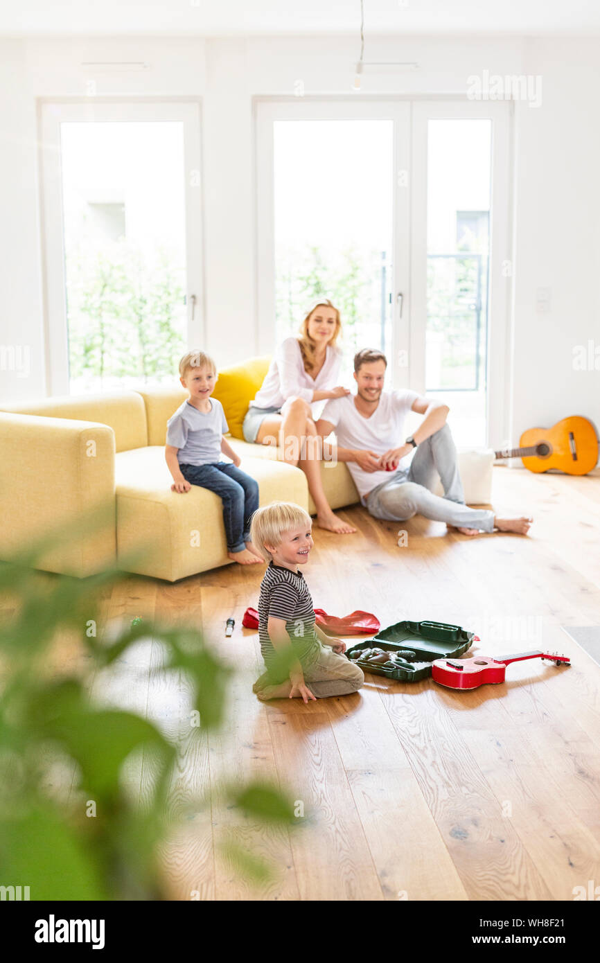 Happy family with two sons in living room of their new home Stock Photo ...