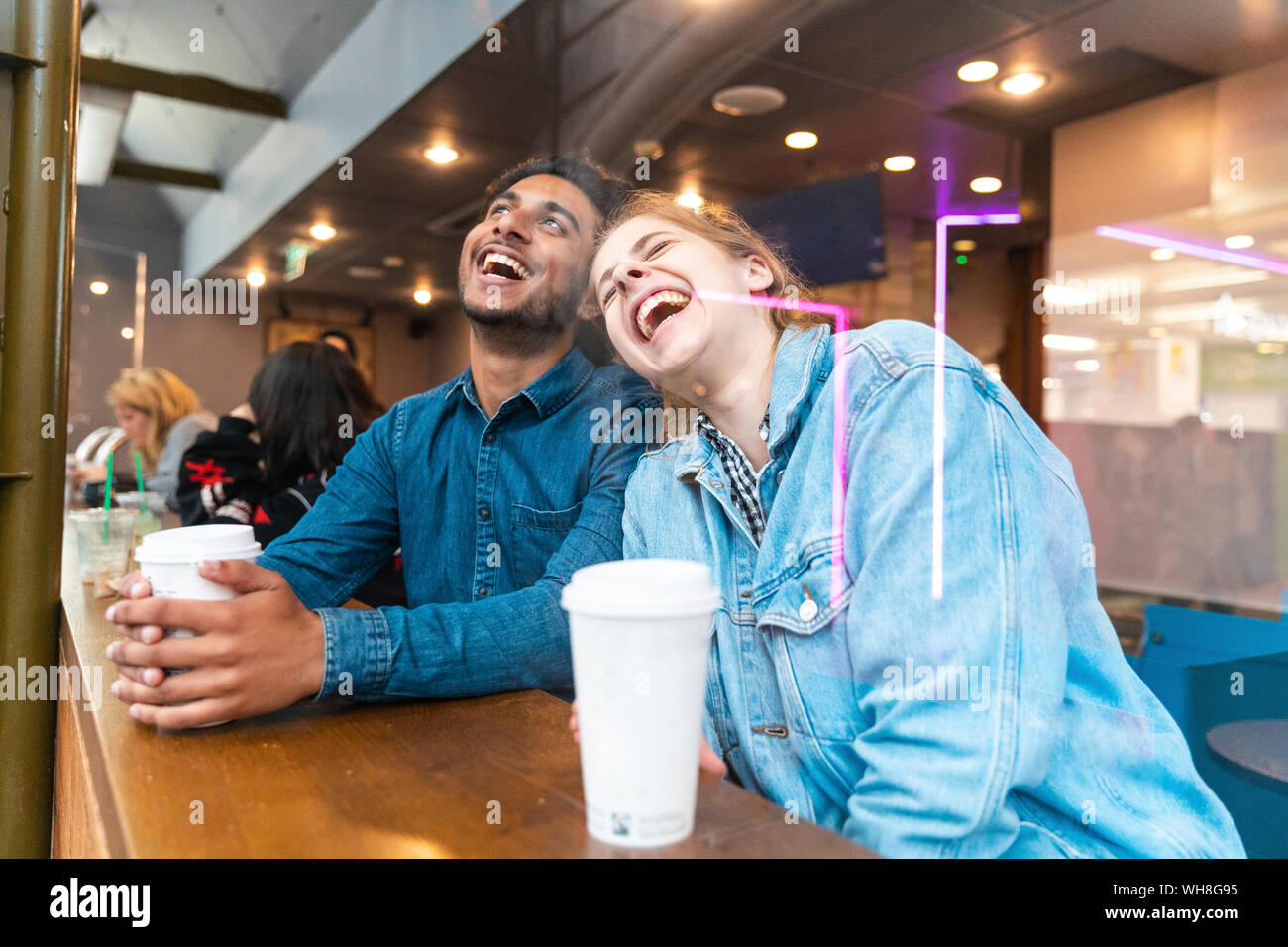 Friends having fun together in a coffee shop Stock Photo - Alamy