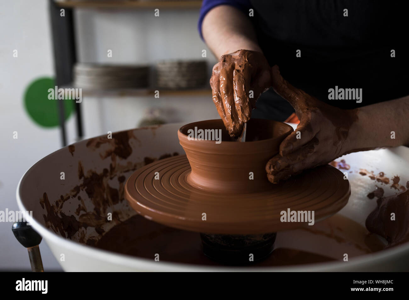 Potter forming clay on a wheel Stock Photo - Alamy
