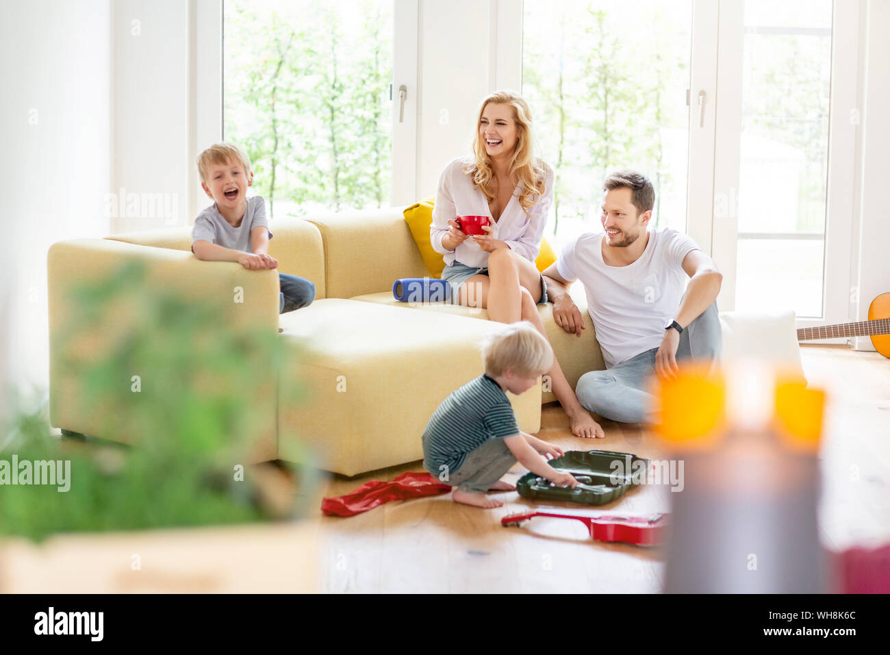 Happy family with two sons in living room of their new home Stock Photo ...