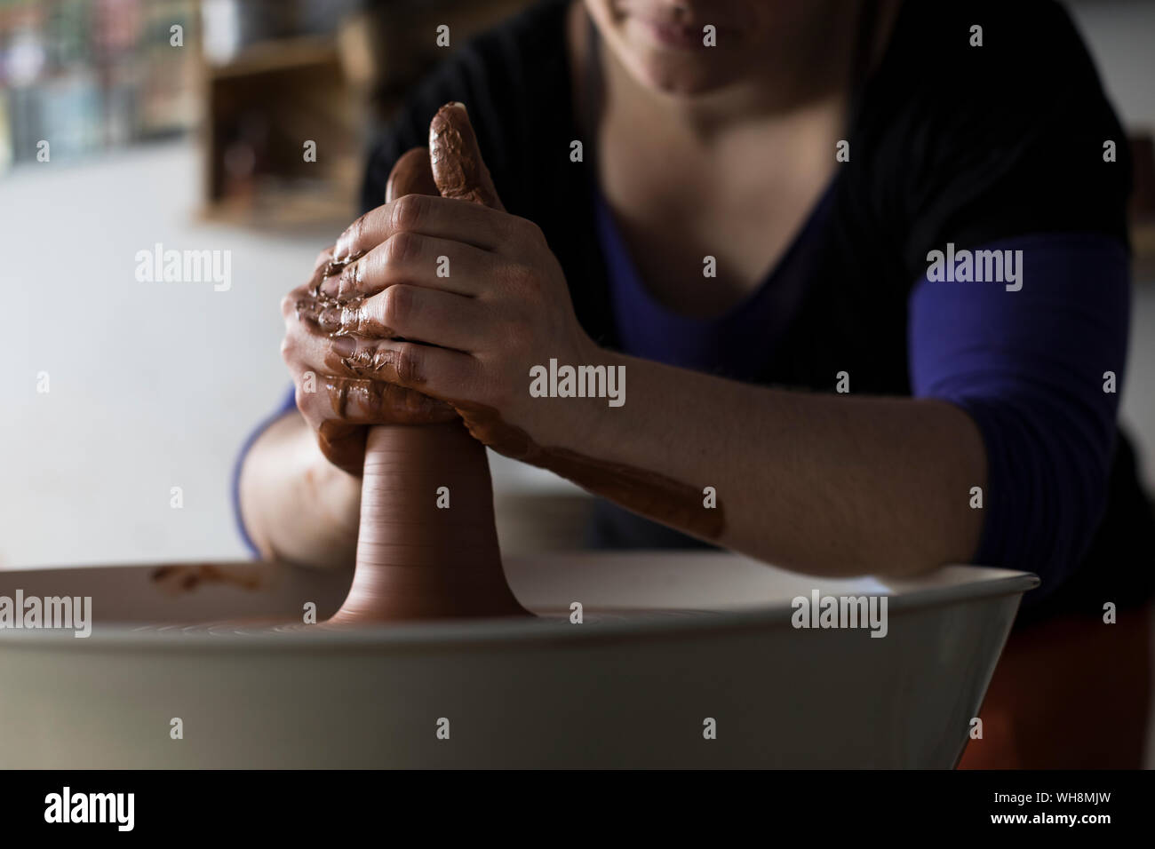 Potter forming clay on a wheel Stock Photo - Alamy