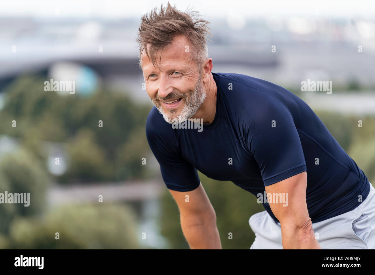 Portrait of a sporty man standing outside Stock Photo - Alamy