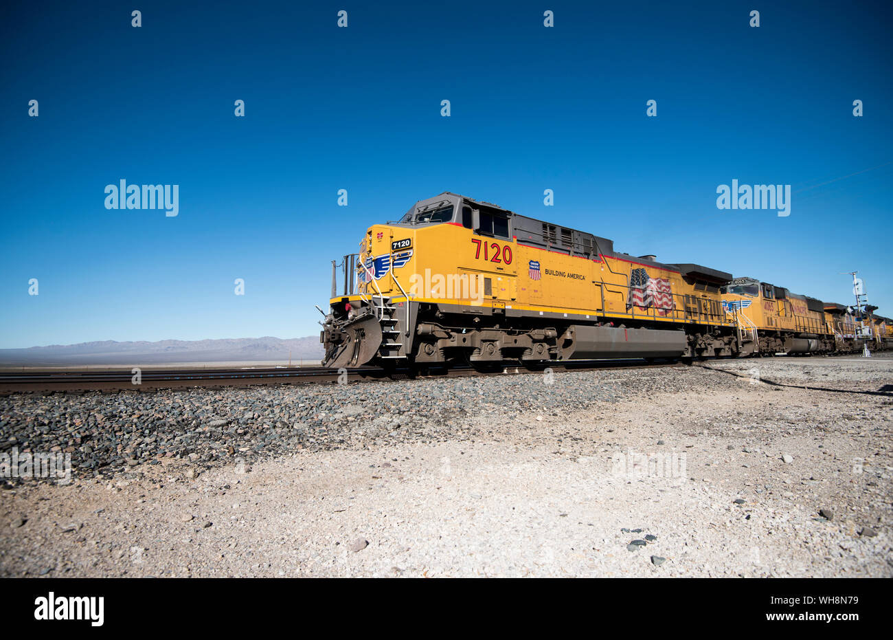 A Union Pacific freight train passes the railroad crossing in Nipton ...