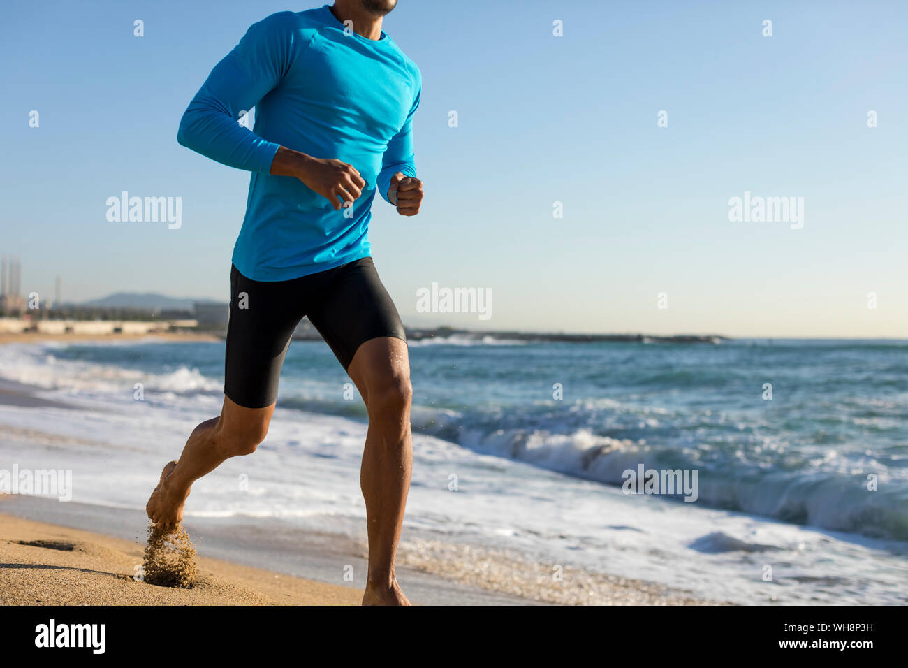 Man jogging on the beach Stock Photo - Alamy
