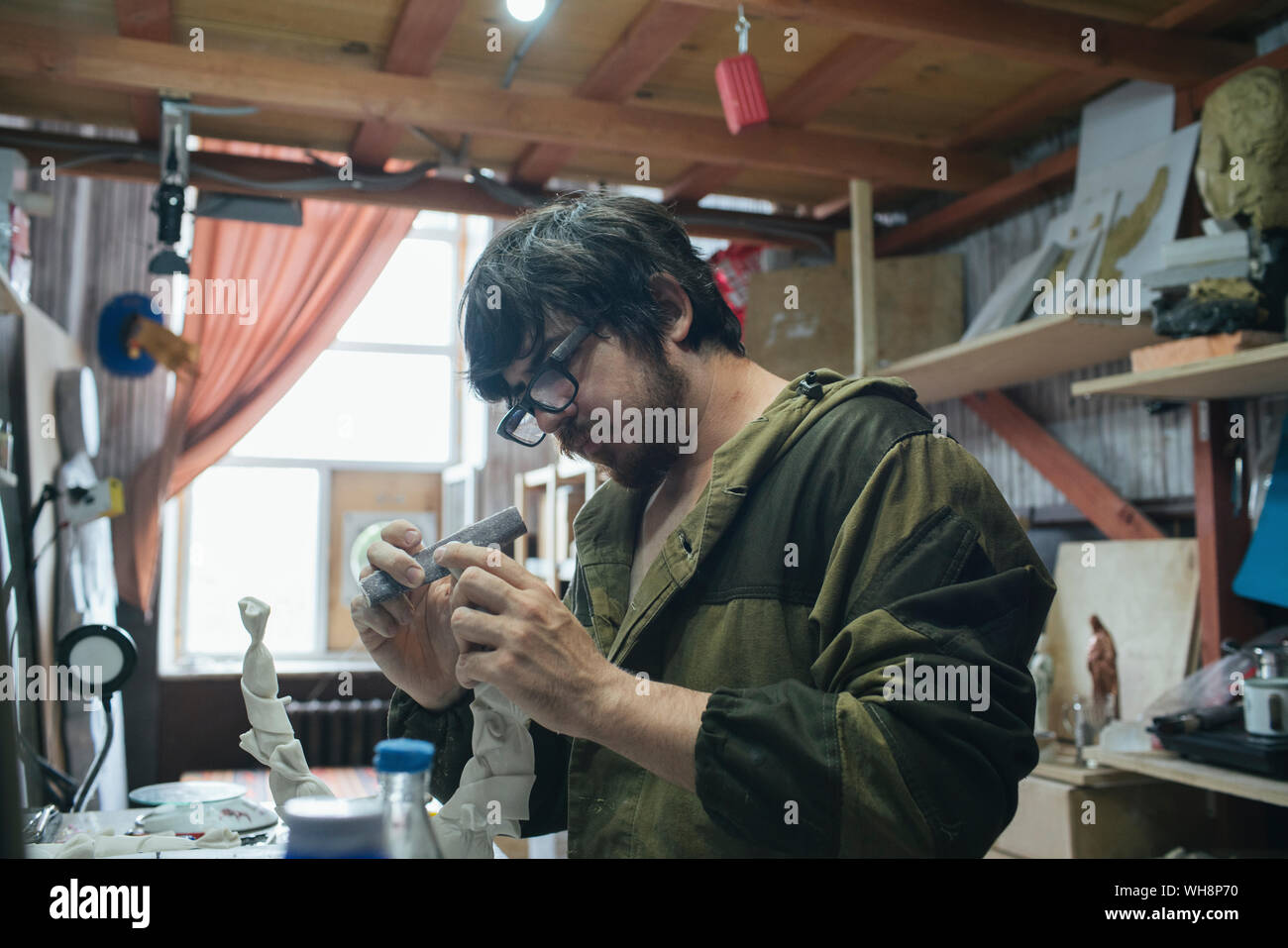 Sculptor working on an object Stock Photo - Alamy