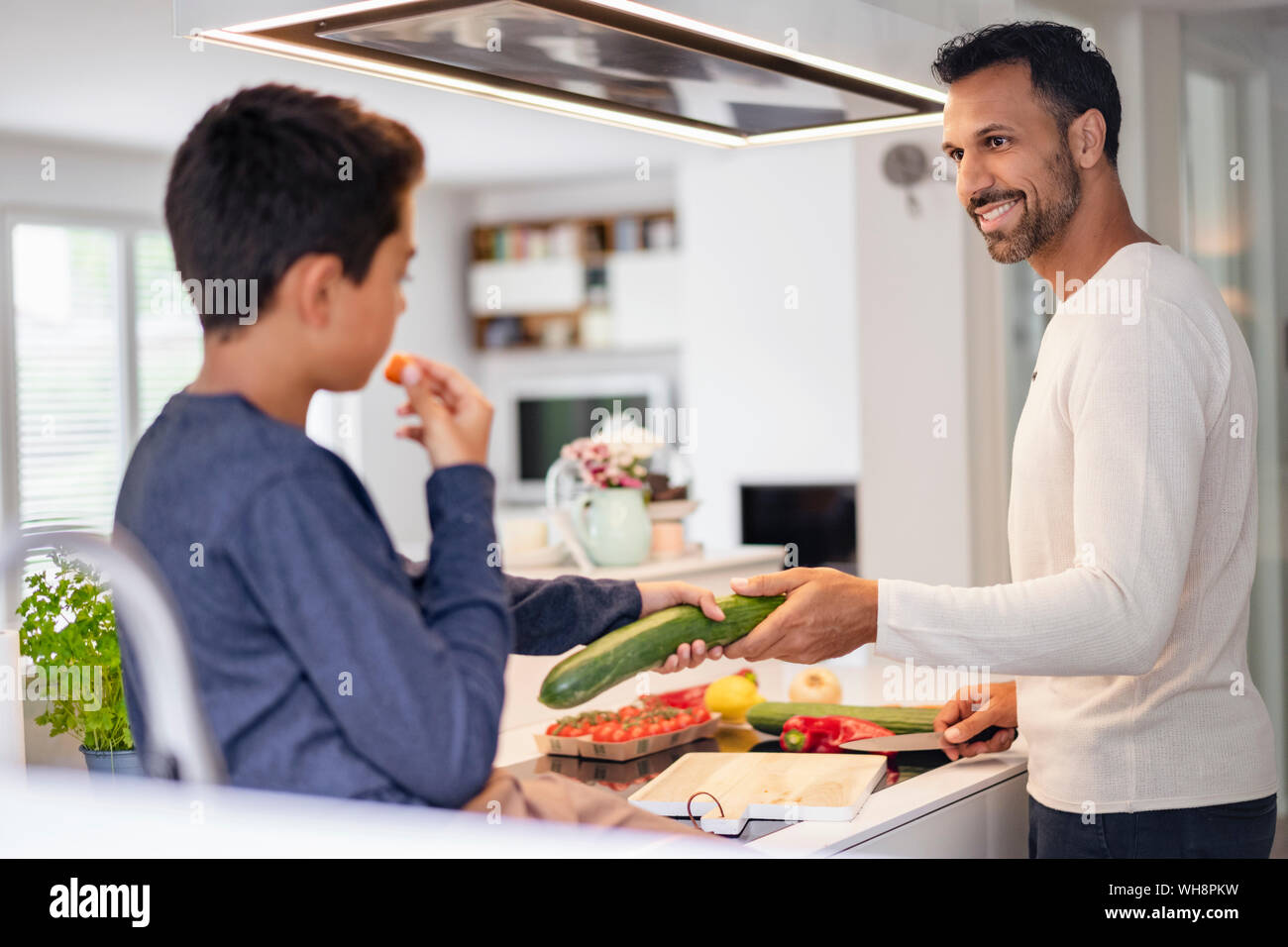 Father and son cooking in kitchen at home together Stock Photo - Alamy