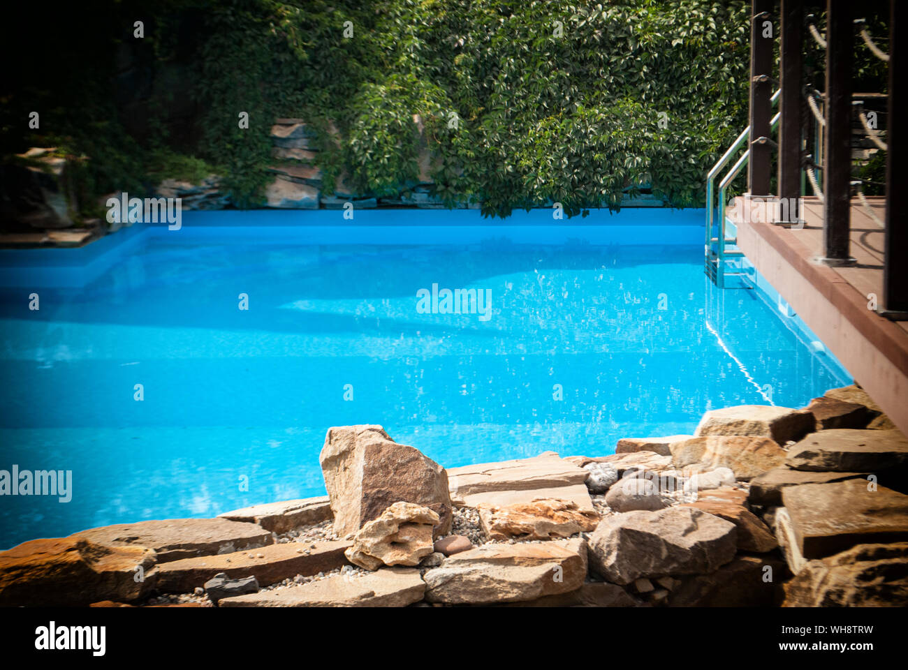 private pool with perimeter stones and green spaces in the background ...