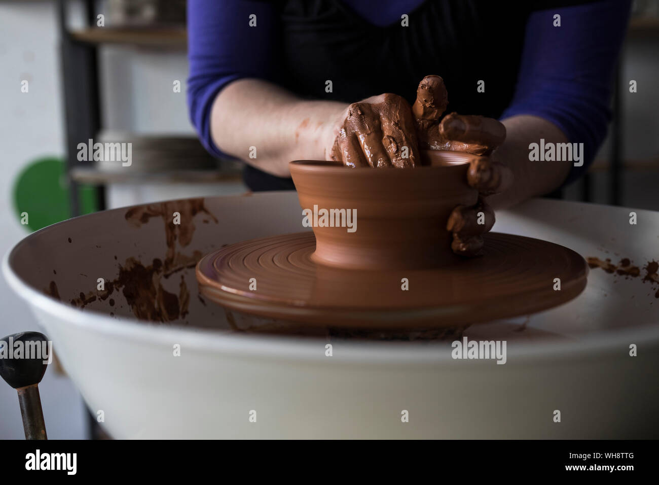 Potter forming clay on a wheel Stock Photo - Alamy