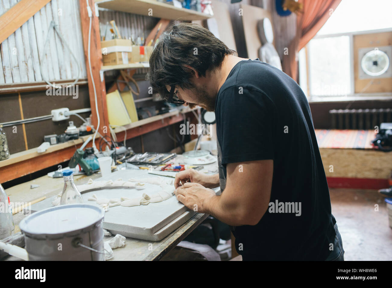 Sculptor working on an object Stock Photo - Alamy
