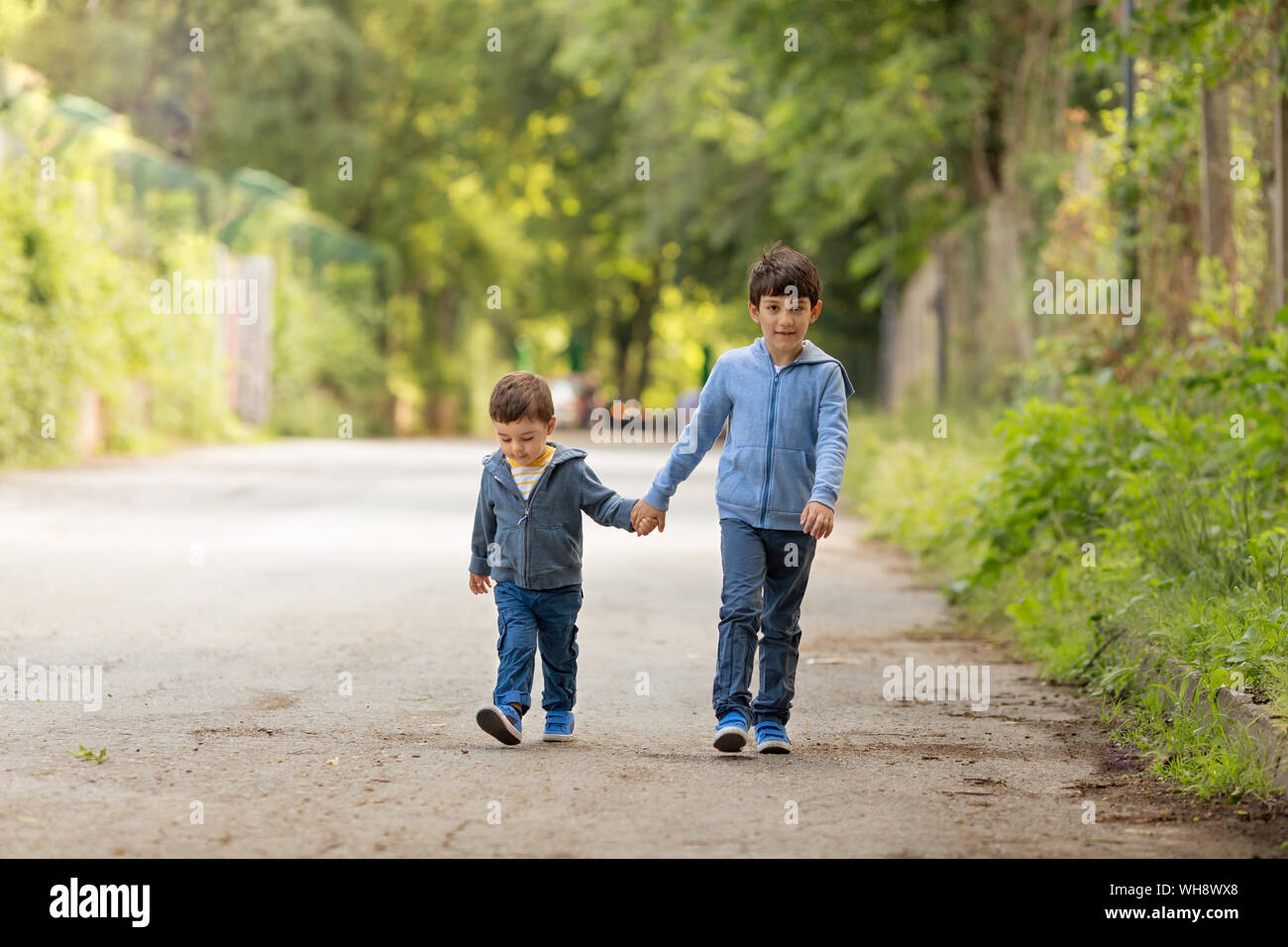 Two brothers walking hi-res stock photography and images - Alamy