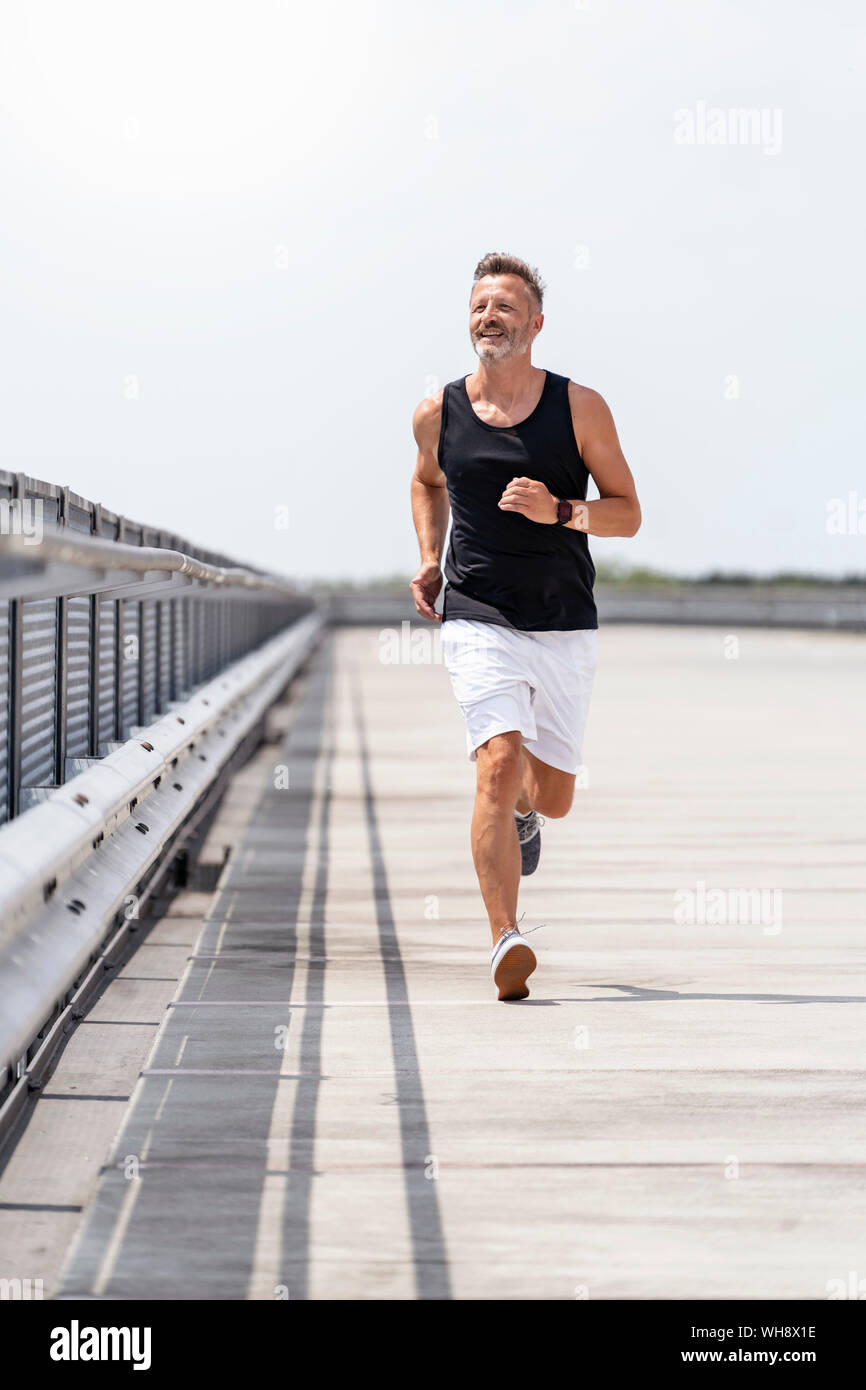 Sporty man jogging Stock Photo - Alamy