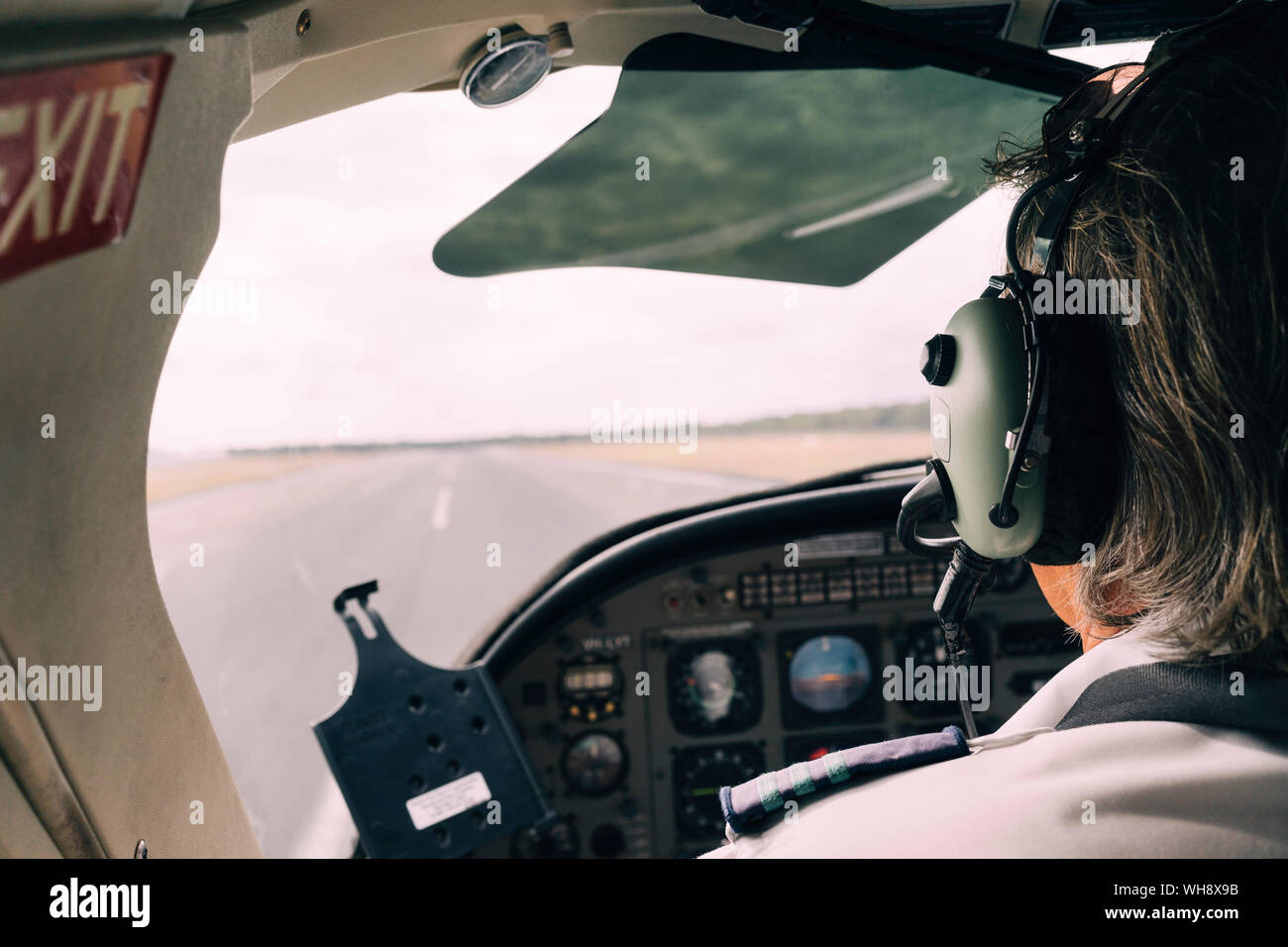 Pilot and dashboard of a small plane on the runway ready to take off ...