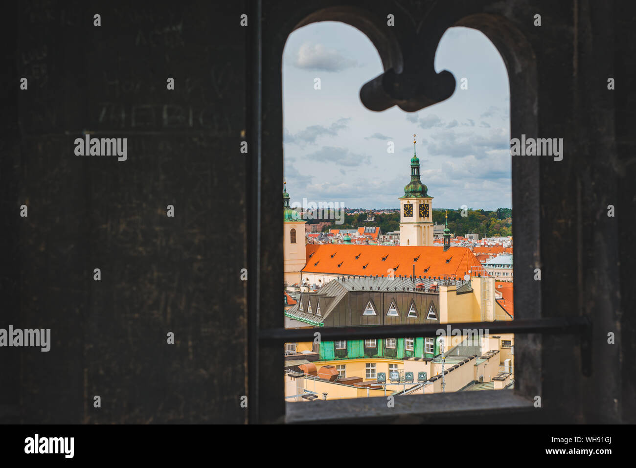 view of prague city through old window of the church. travel concept ...