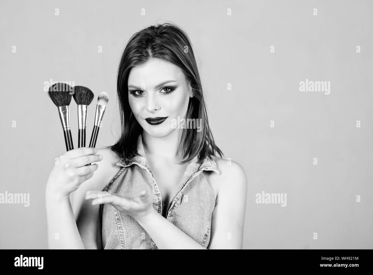 Makeup cosmetics concept. Emphasize femininity. Girl apply eye shadows ...