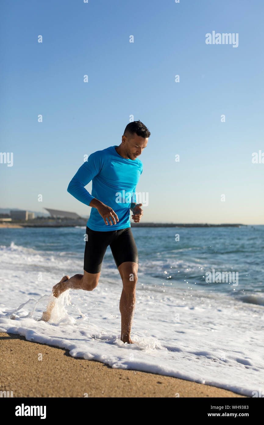 Man jogging on the beach Stock Photo - Alamy