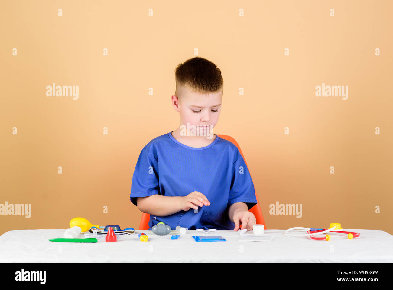 Healthy life. Kid little doctor sit table with stethoscope and medical ...