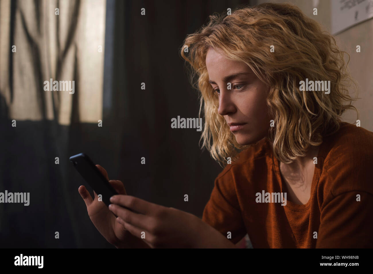 Serious woman using cell hi-res stock photography and images - Alamy