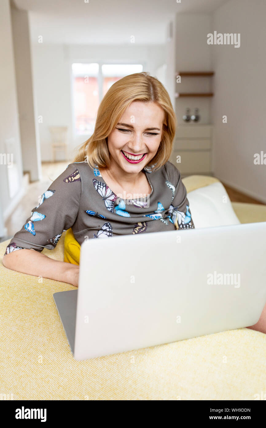 Laughing young woman with laptop hi-res stock photography and images ...