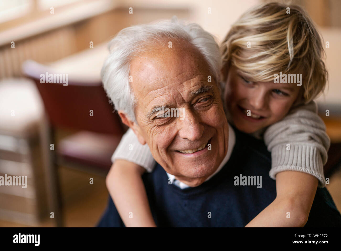 Happy grandson hugging grandfather Stock Photo - Alamy