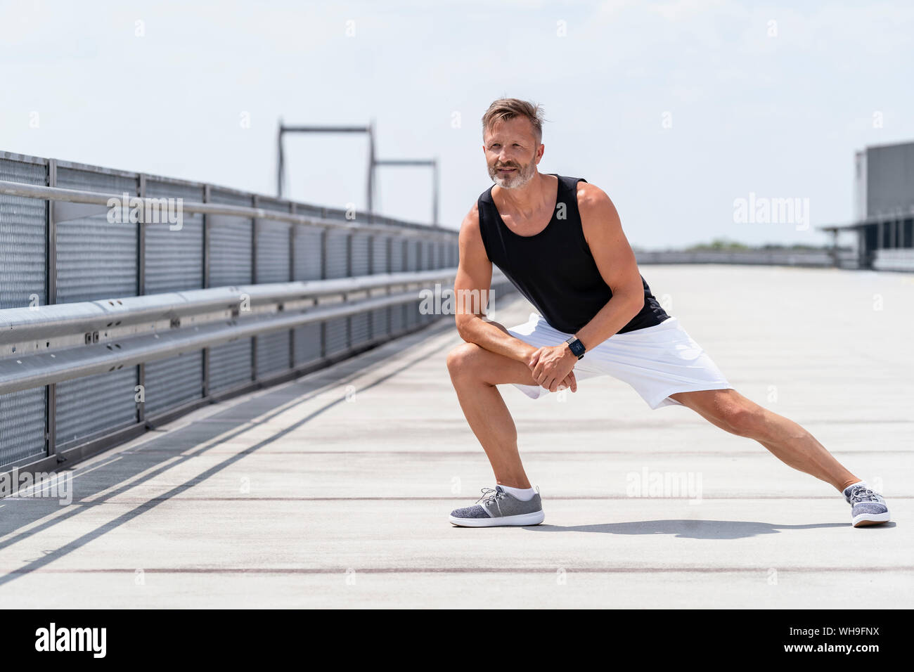 Sporty man stretching outside Stock Photo - Alamy