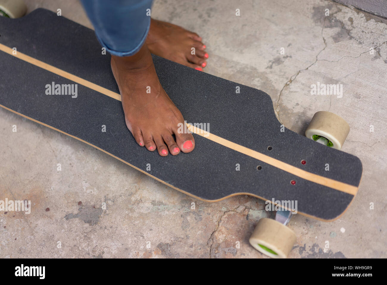 Young women's foot on skateboard Stock Photo - Alamy