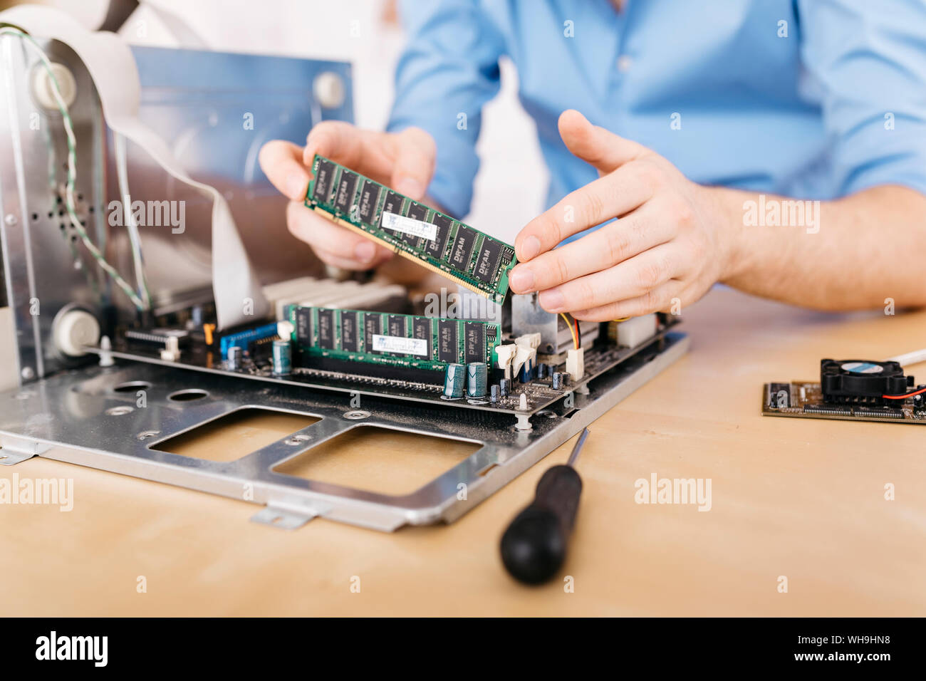 Close-up of technician repairing a desktop computer, changing the ...