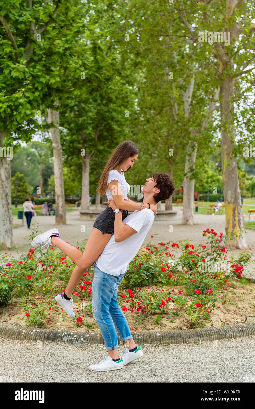 Young couple in a park, man lifting up the woman Stock Photo - Alamy
